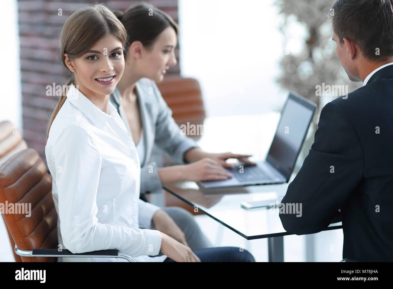 two office workers sitting behind a Desk. office life Stock Photo - Alamy