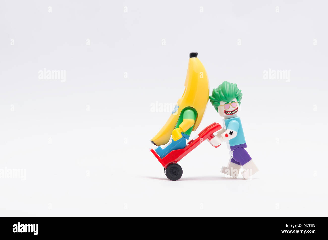 lego joker mini figure pushing trolley with banana suit guy standing on ...