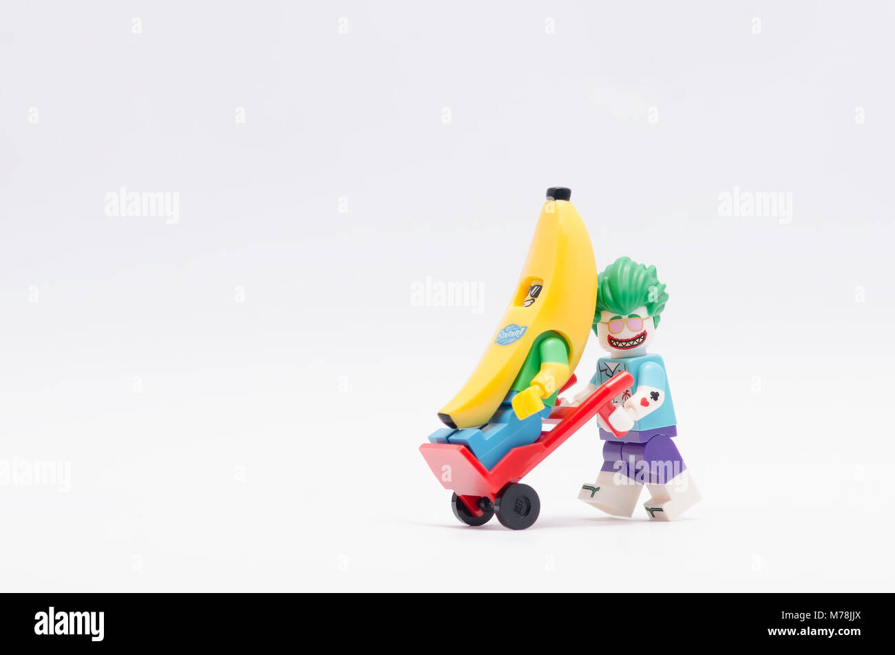 lego joker mini figure pushing trolley with banana suit guy standing on ...