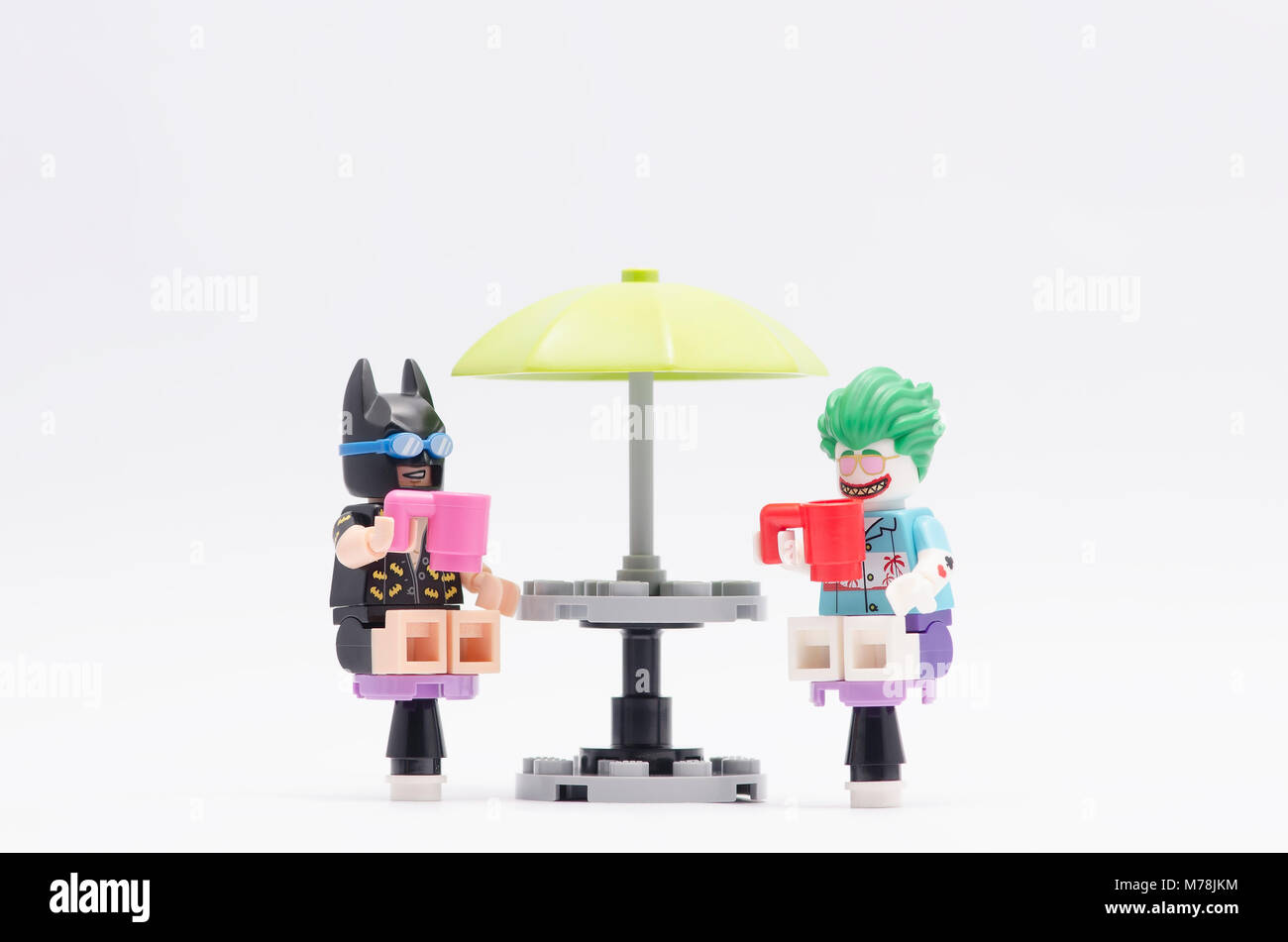 lego joker and batman mini figures having a drink. isolated on white ...