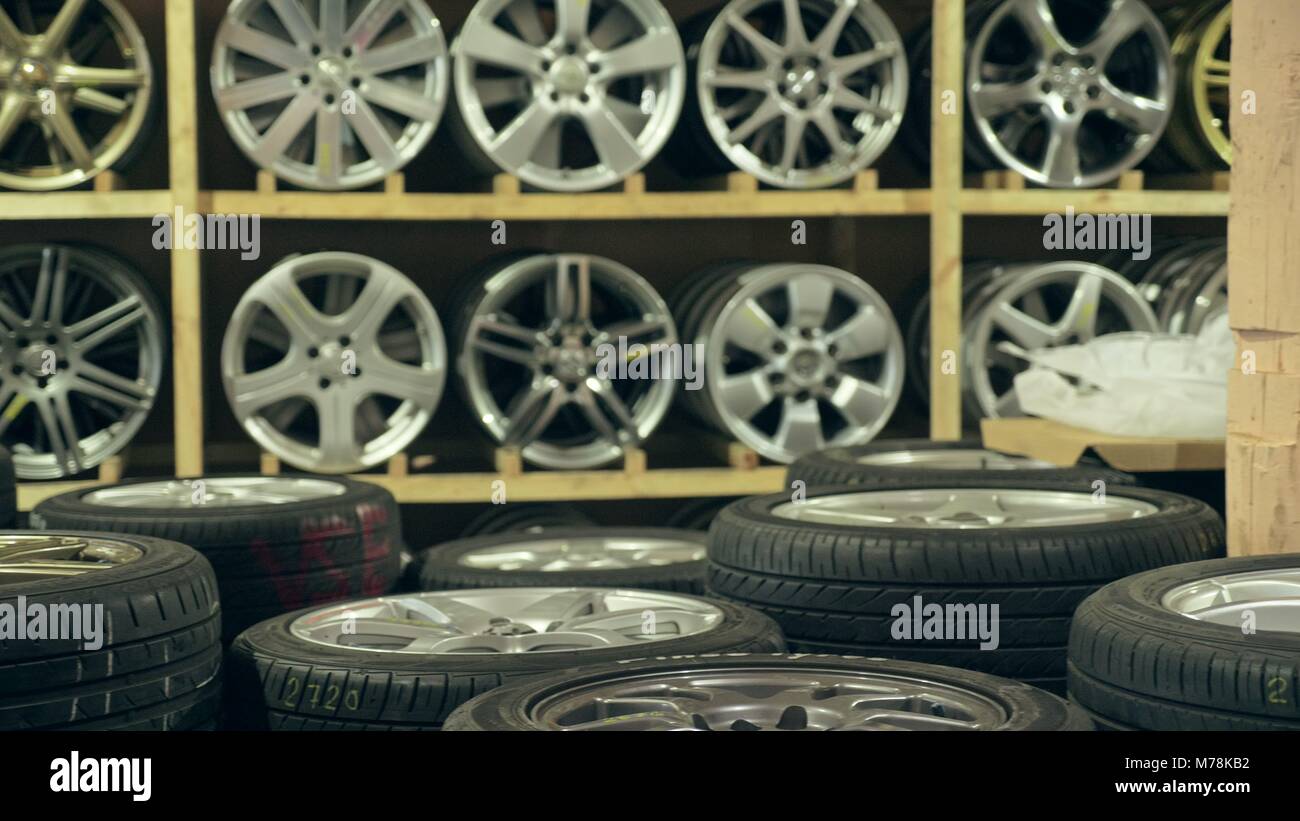 Alloy wheels in the store on the shelves. The camera moves from left to ...