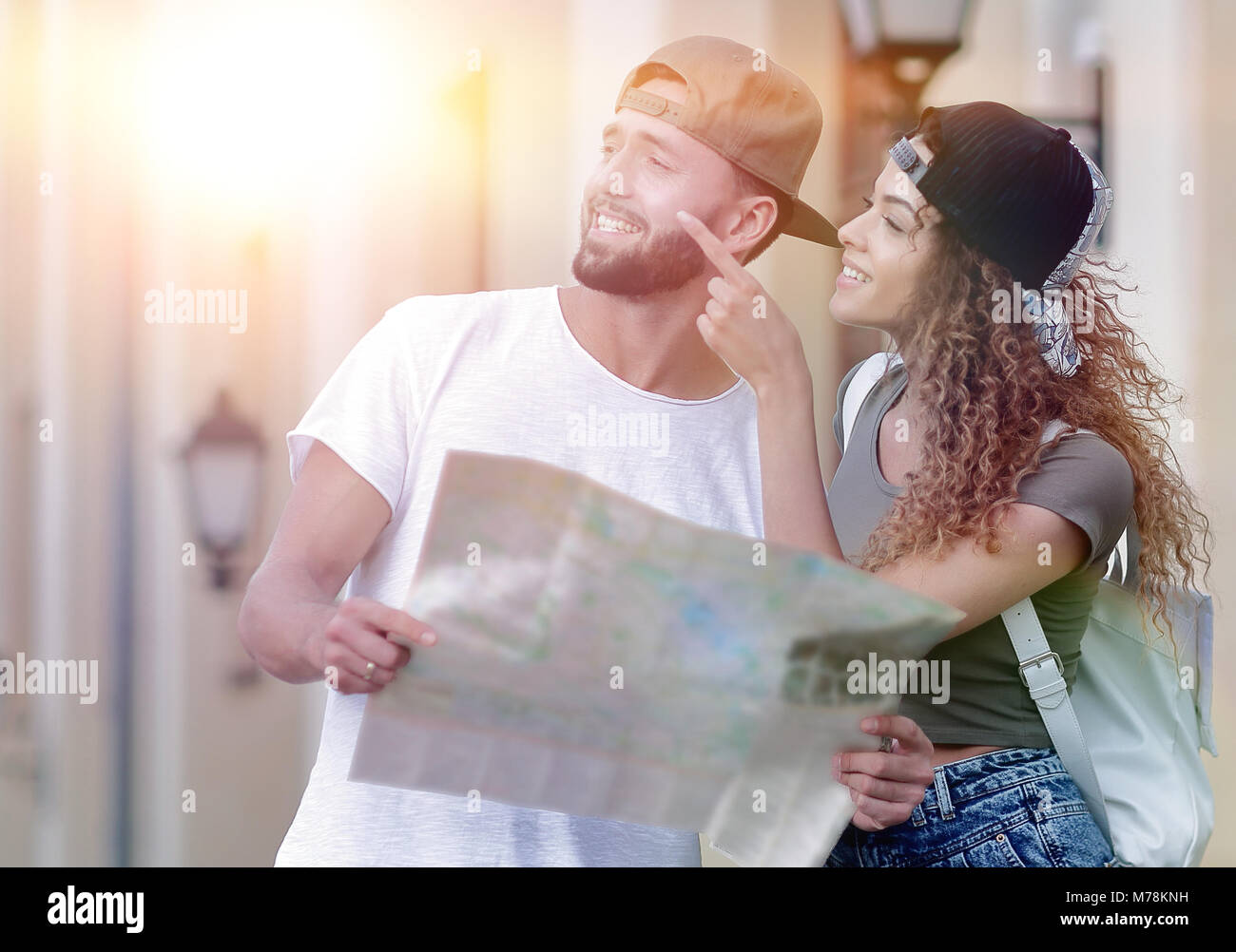 Happy couple of tourists with map looking for a way Stock Photo - Alamy