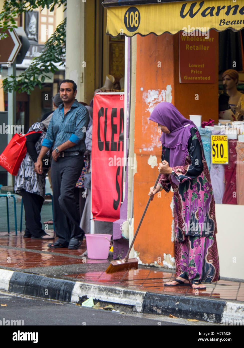 Woman sweeping street hi-res stock photography and images - Alamy
