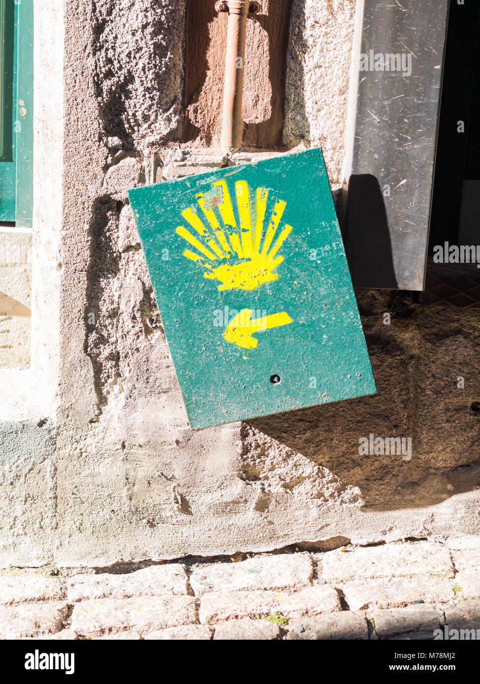 The yellow scallop shell signing the way to Santiago de Compostela in ...