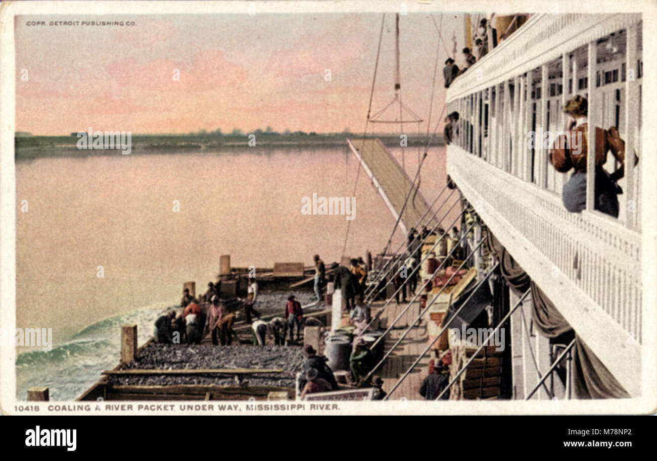 This photograph depicts the process of coaling a river packet boat ...