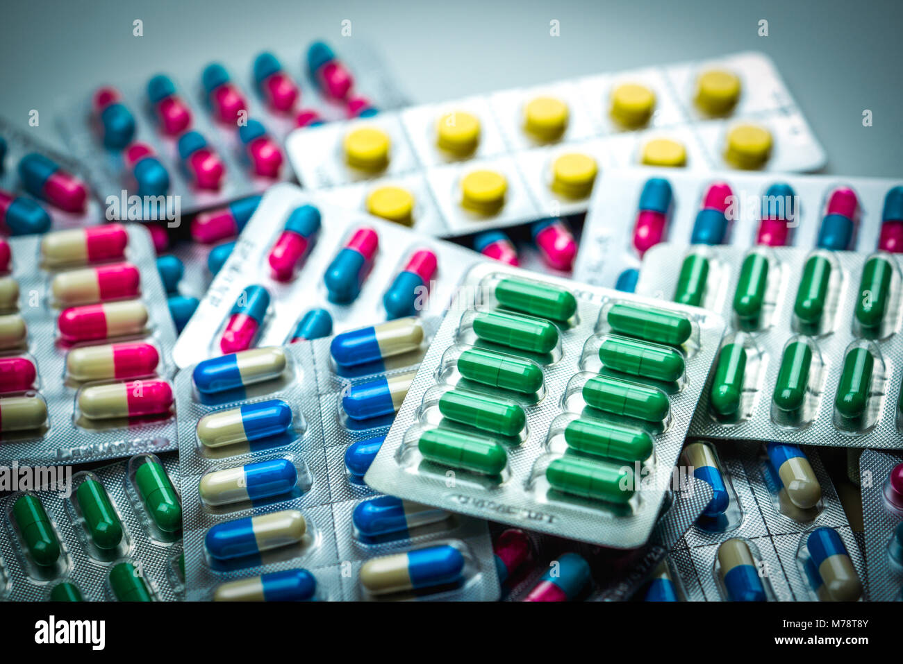 Pile of colorful tablets and capsules pills in blister packs. Global ...