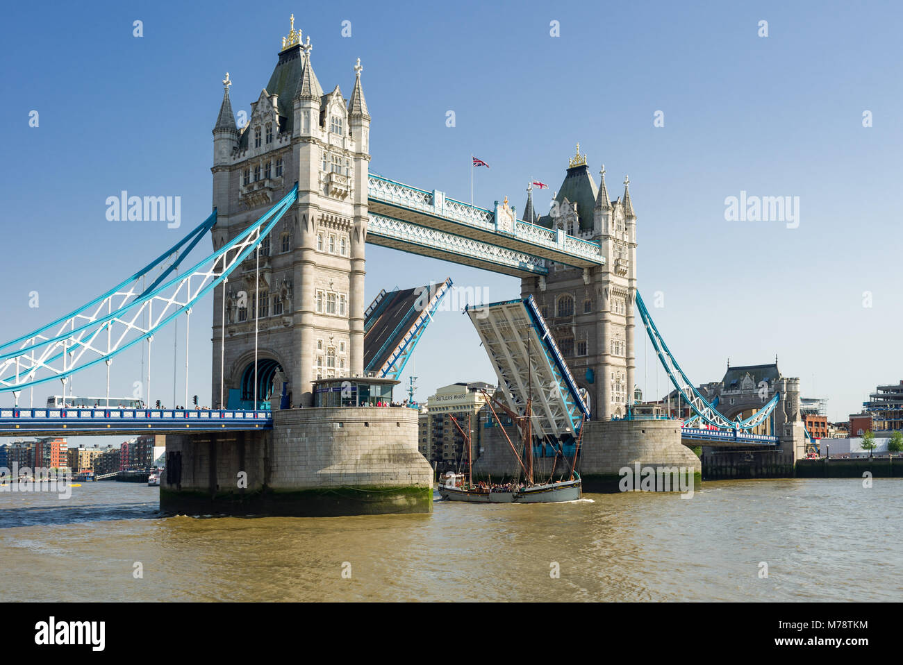 Tower Bridge with drawbridge opened to let a tall mast ship sail ...