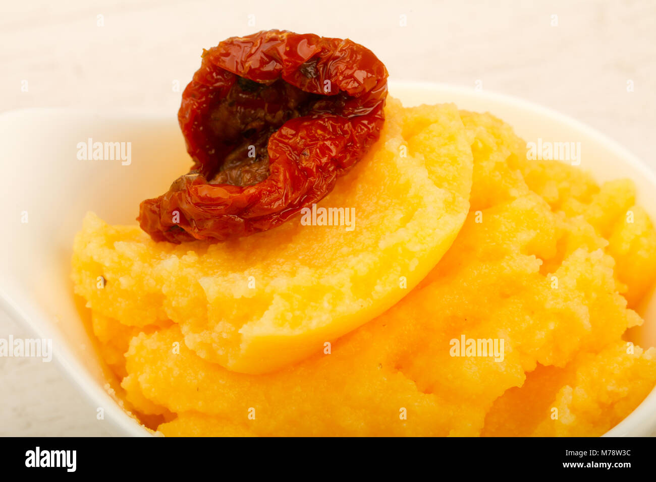 Polenta with dry tomato Stock Photo - Alamy
