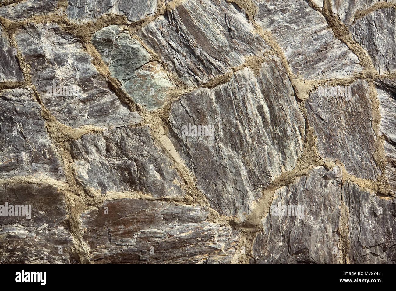 Texture of old rock wall for background. A wall of rough round stones ...