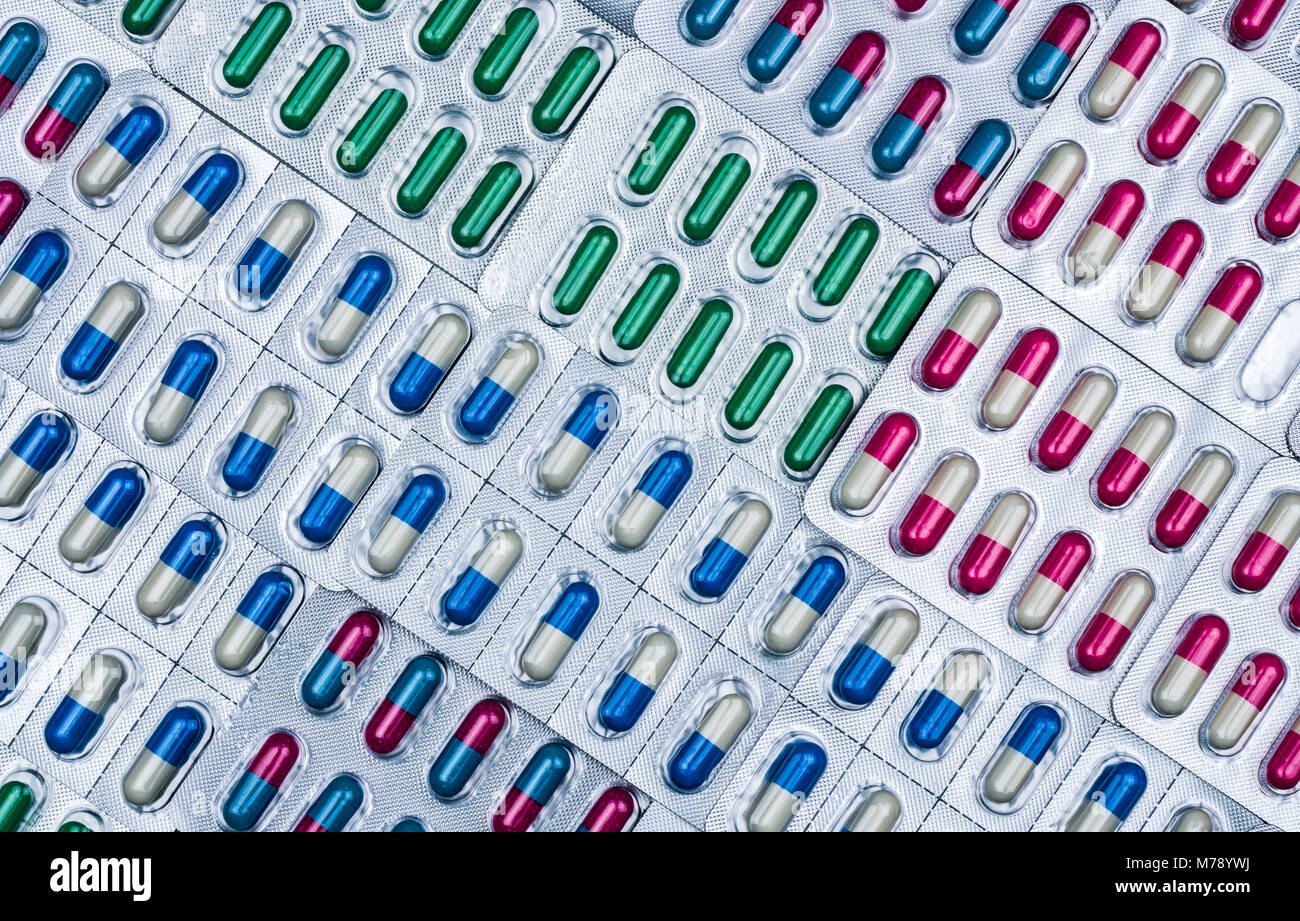 Full frame of colorful antimicrobial capsule pills. Quality control ...