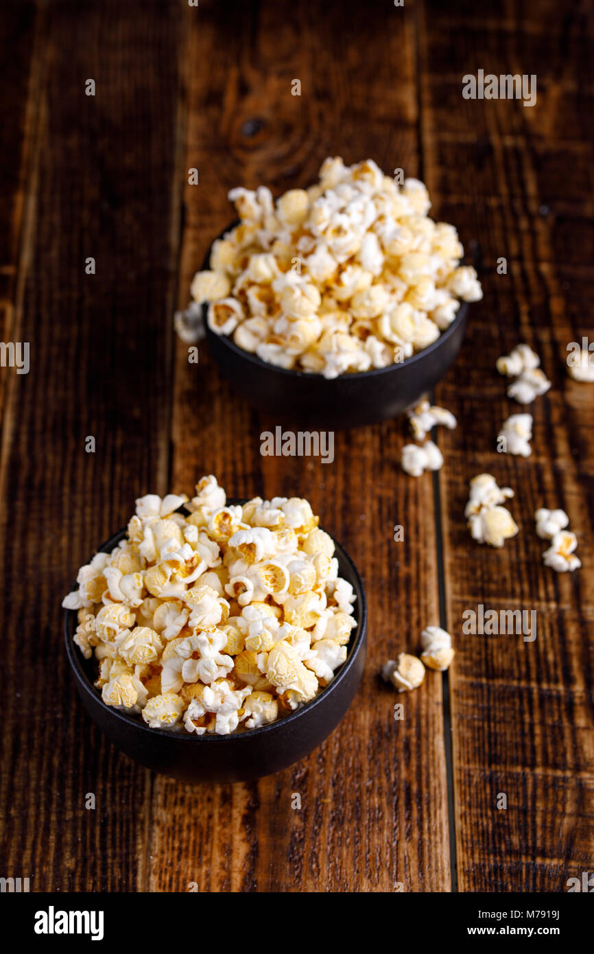 Still life on a wooden background with two bowls of popcorn. View from ...