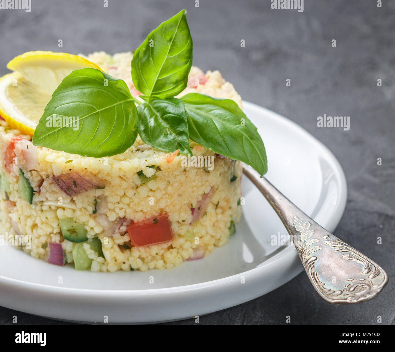Couscous (bulgur) salad with fresh vegetables - cucumber, tomato, red ...