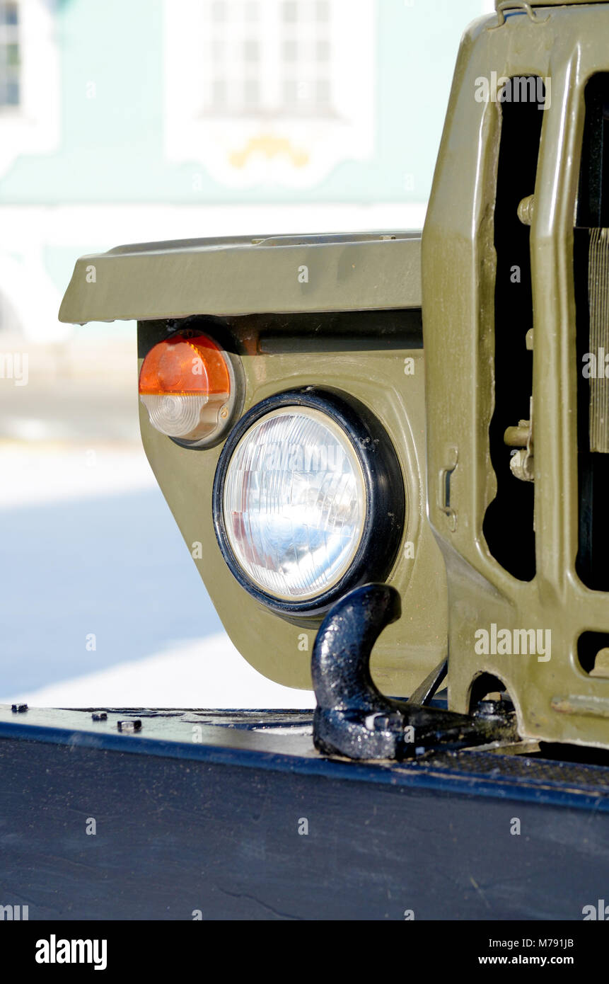 A headlight on a military truck.In the dark, the headlight illuminates ...