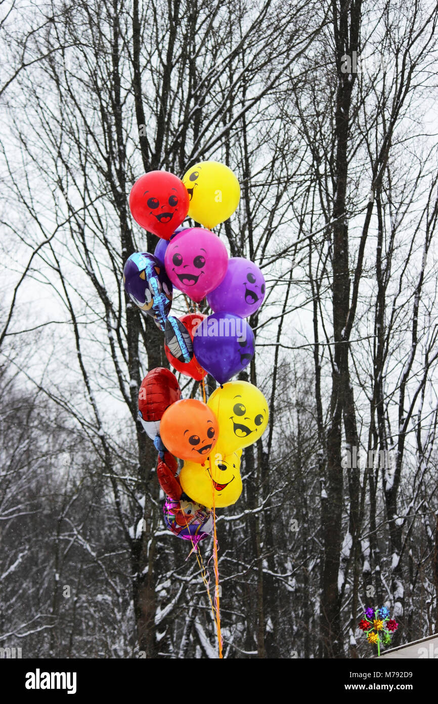 Colorful balloons on a background of black and white trees at the ...