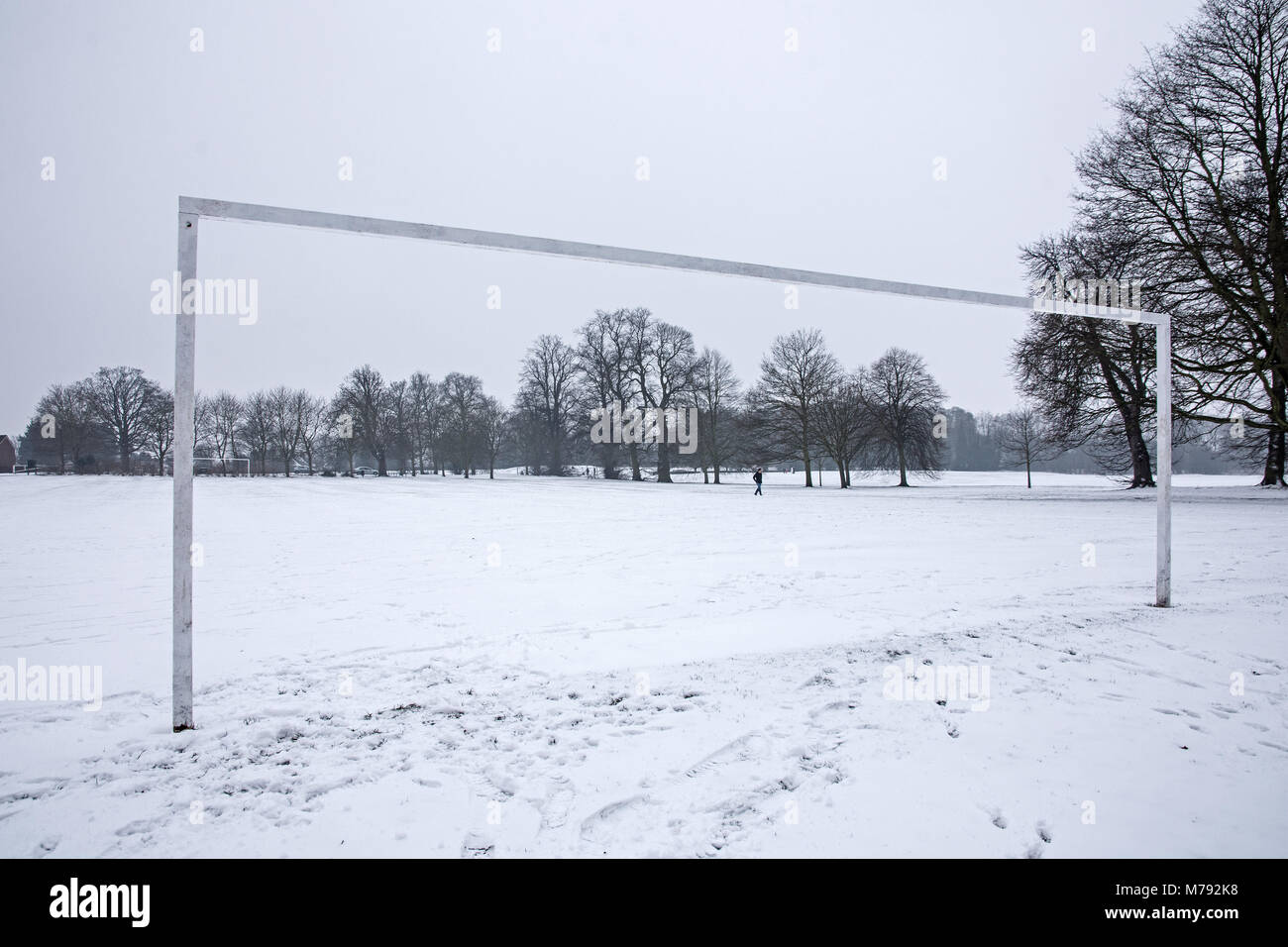 Empty snow covered football field seen through goal posts in ...