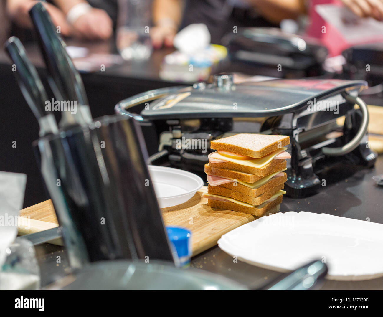 Cooking sandwiches with cheese and ham in electric sandwich maker ...