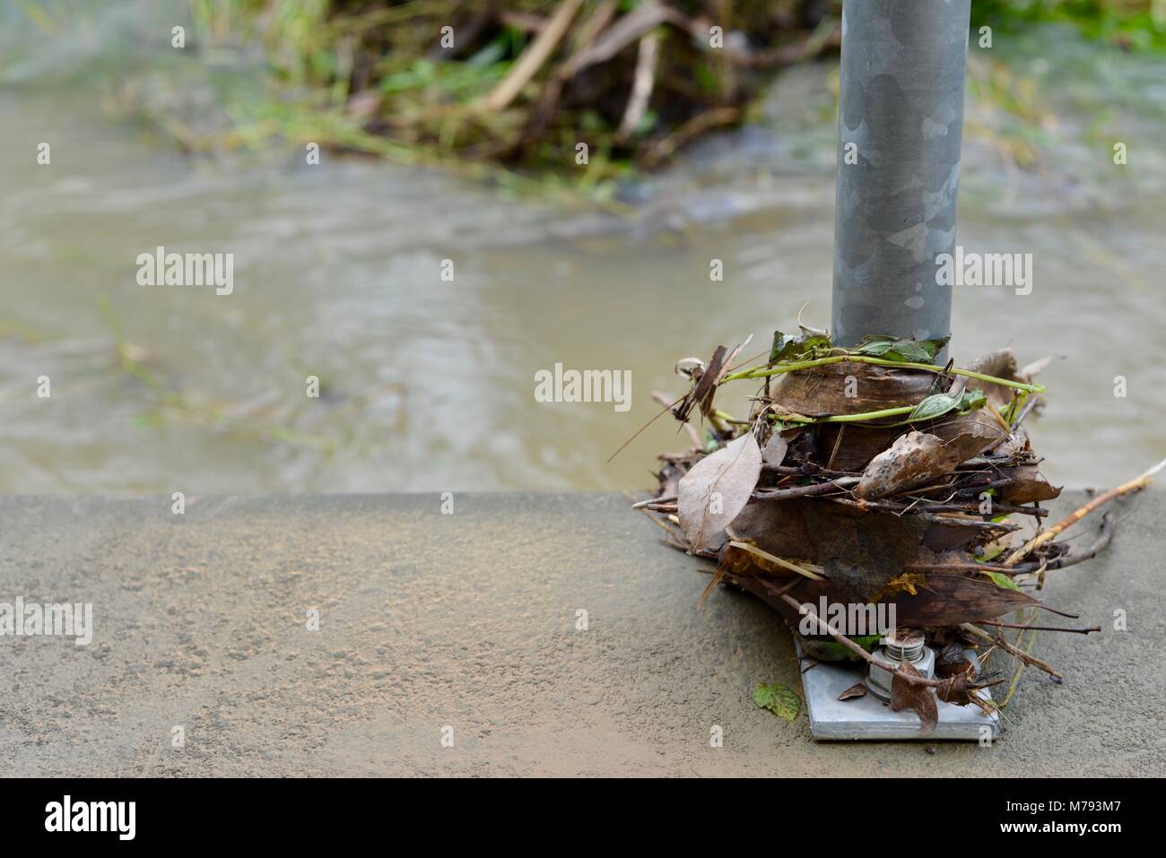 Debris lies over a pedestrian path after storms and heavy rainfall and ...