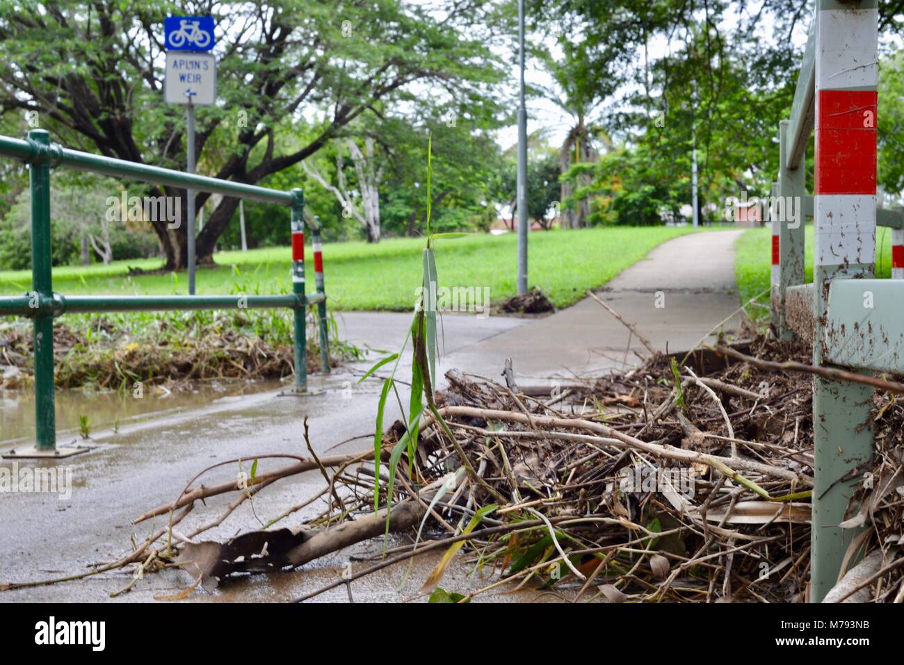 Debris lies over a pedestrian path after storms and heavy rainfall and ...