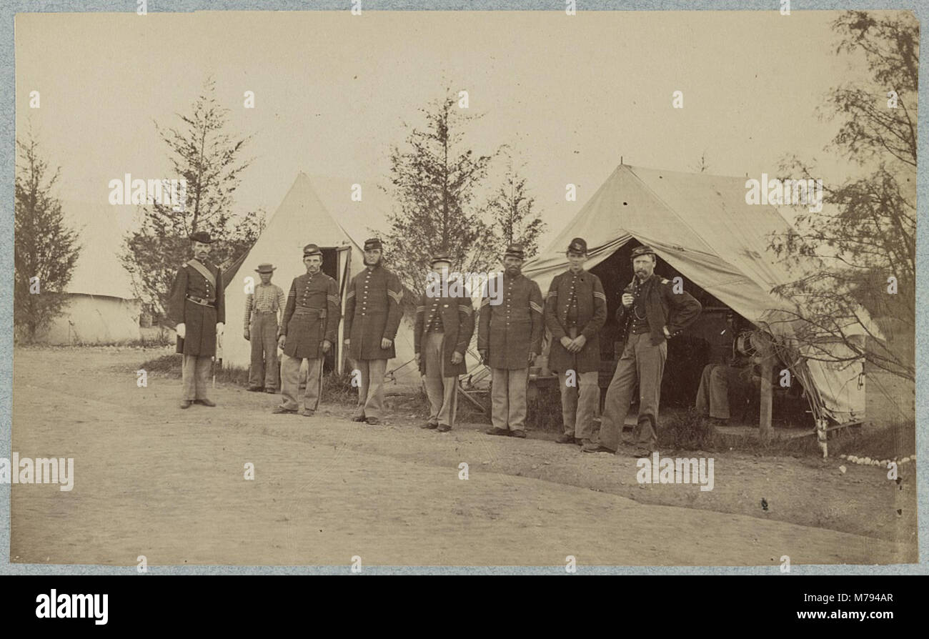 A photograph showing a group of military officers lined up in front of ...