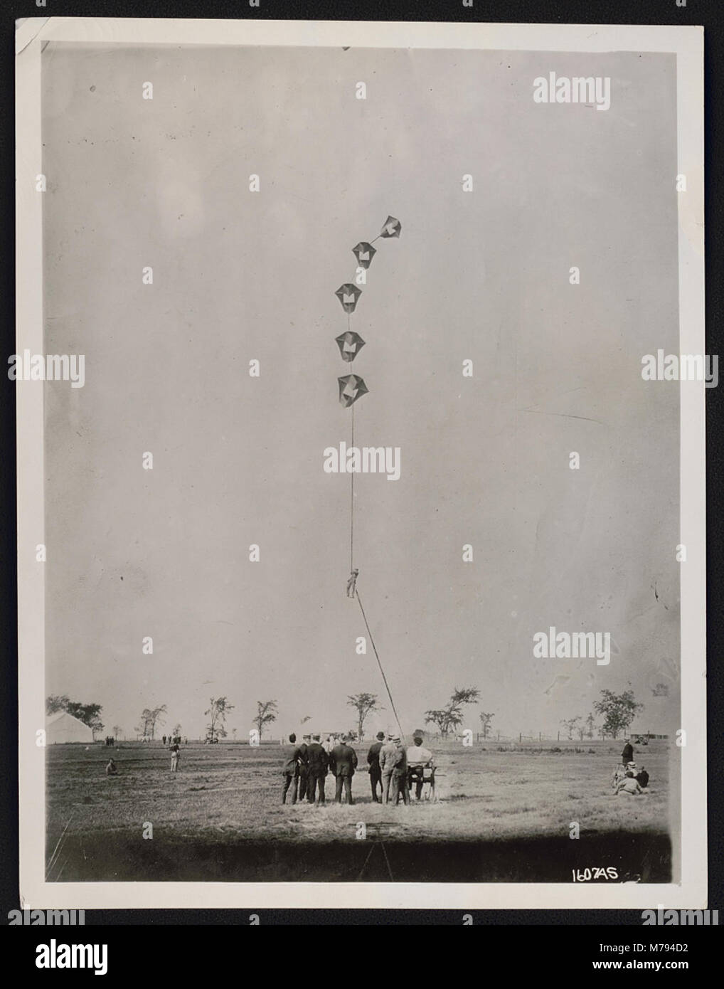This historic photograph shows five Perkins kites lifting a man off the ...