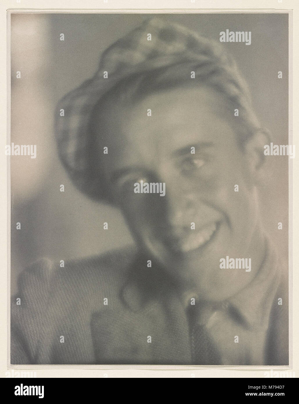 A portrait of Maynard White, dressed in a suit and cap, highlighting ...