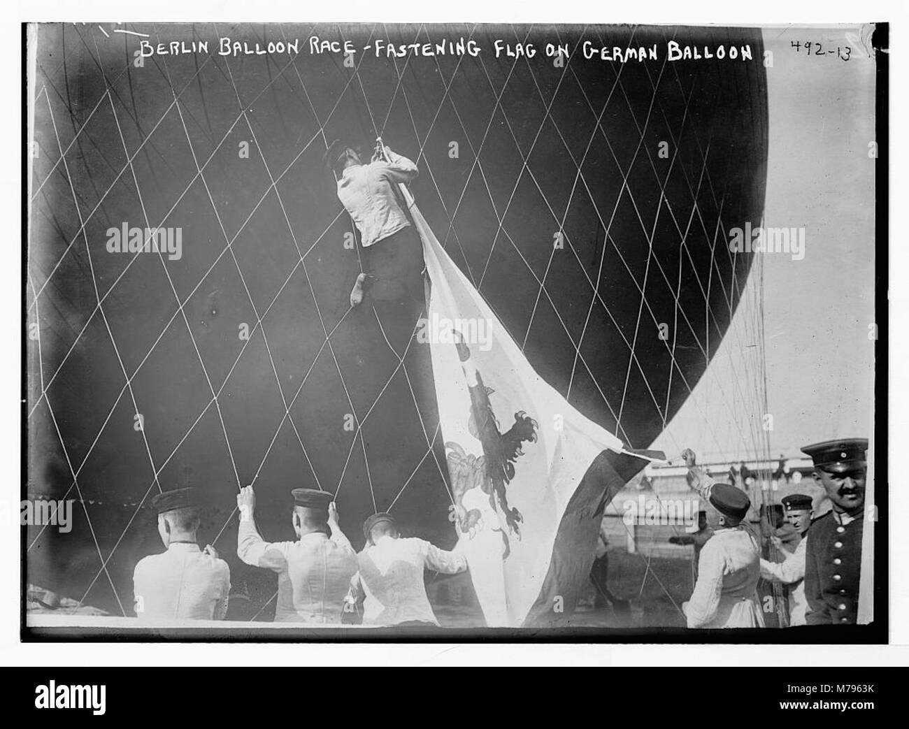 The Berlin balloon race shows a moment where a flag is being fastened ...