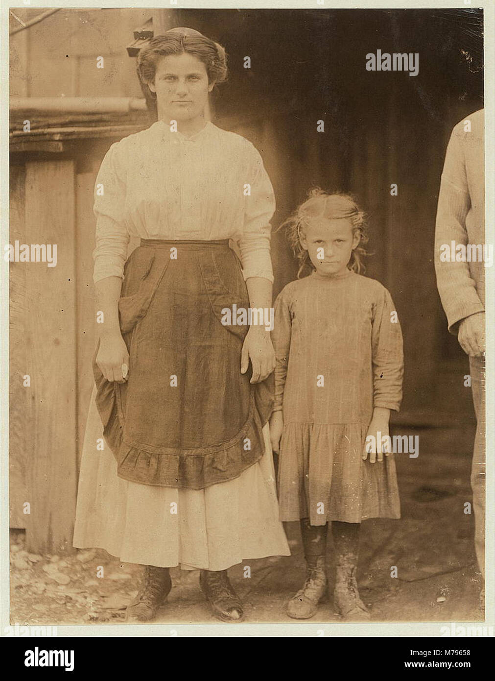A portrait of Bertha, a six-year-old oyster shucker, with her older ...