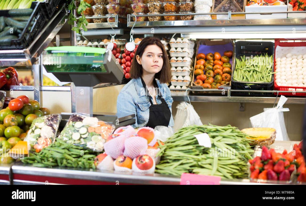 Female shopping assistant demonstrating assortment of grocery shop ...