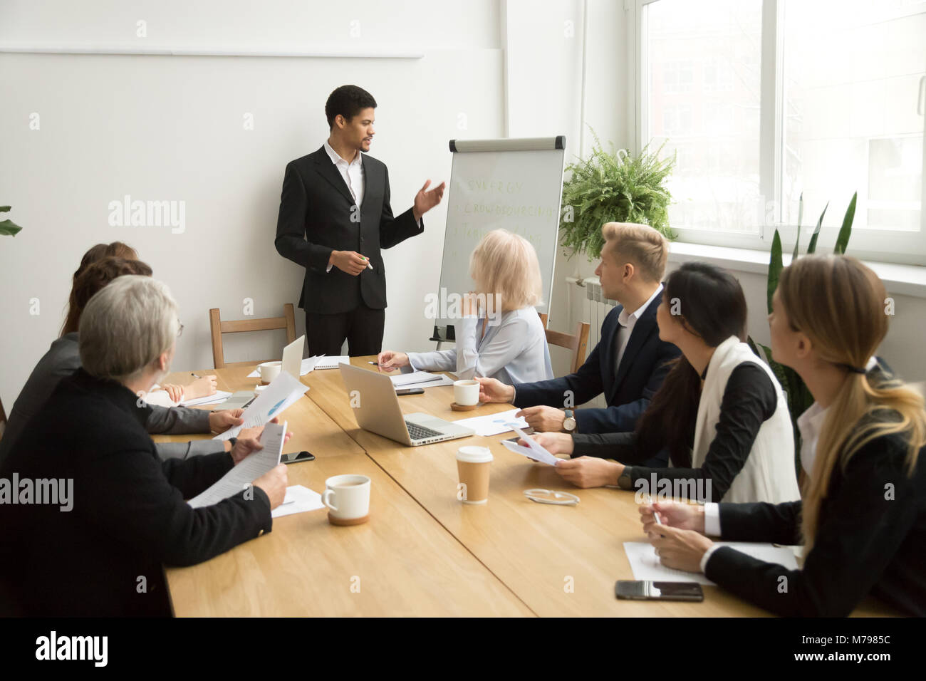 African-american businessman giving presentation explaining team Stock ...