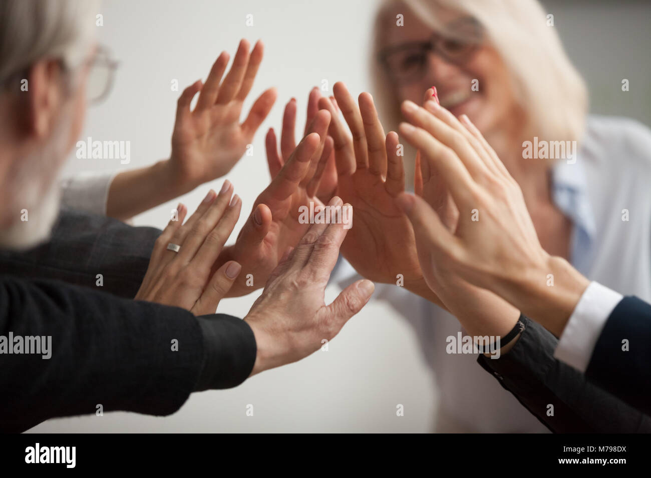 Hands of diverse business people giving high five, close up Stock Photo ...