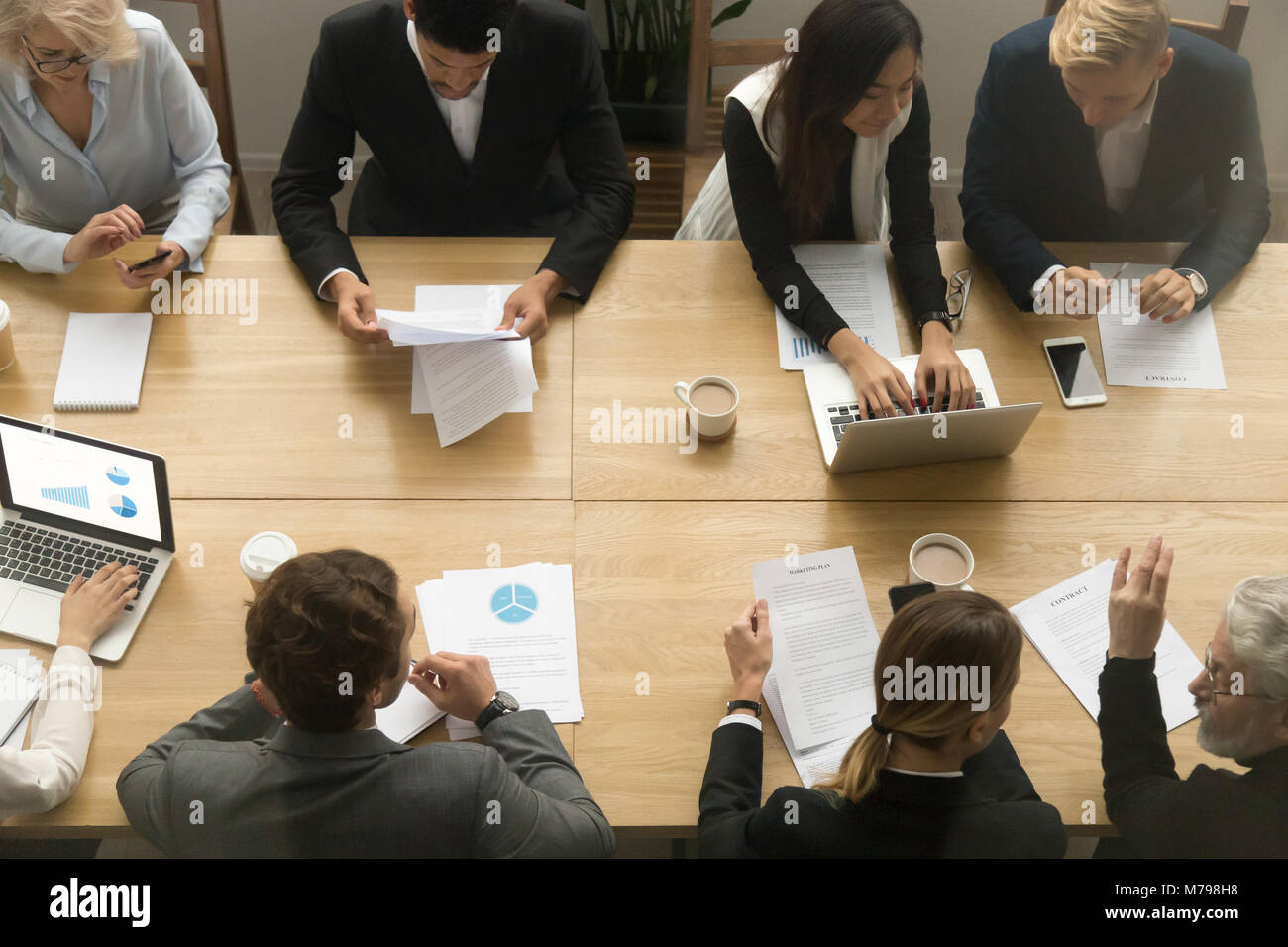 Diverse businesspeople working talking at group office meeting Stock ...