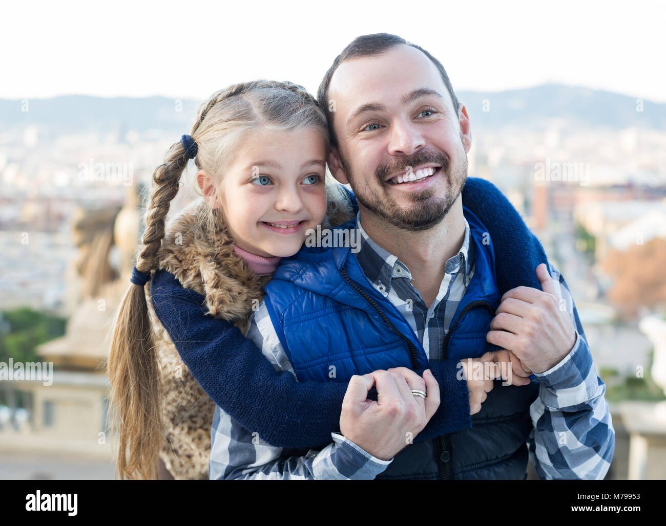 Young father and daughter taking walk in city during sightseeing tour ...