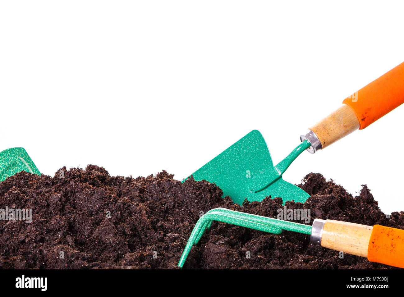 Gardening tool in soil isolated on white Stock Photo - Alamy