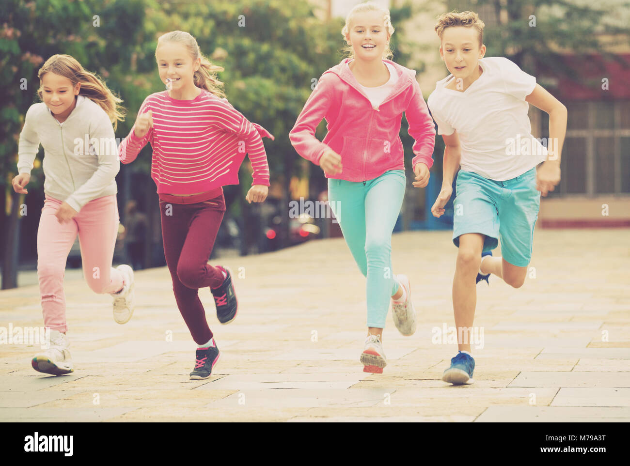 Company of kids are jogning together in the park Stock Photo - Alamy