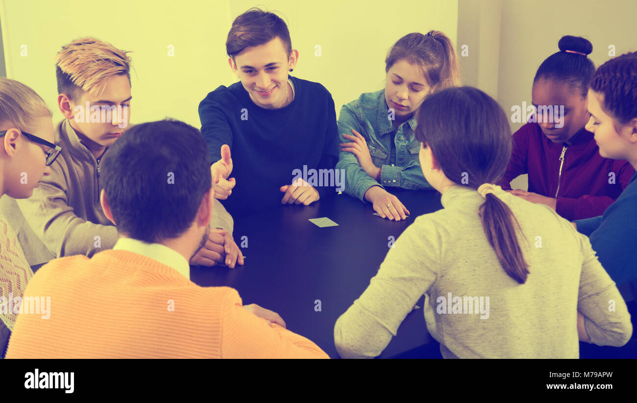 Happy students playing Mafia game at recess Stock Photo - Alamy