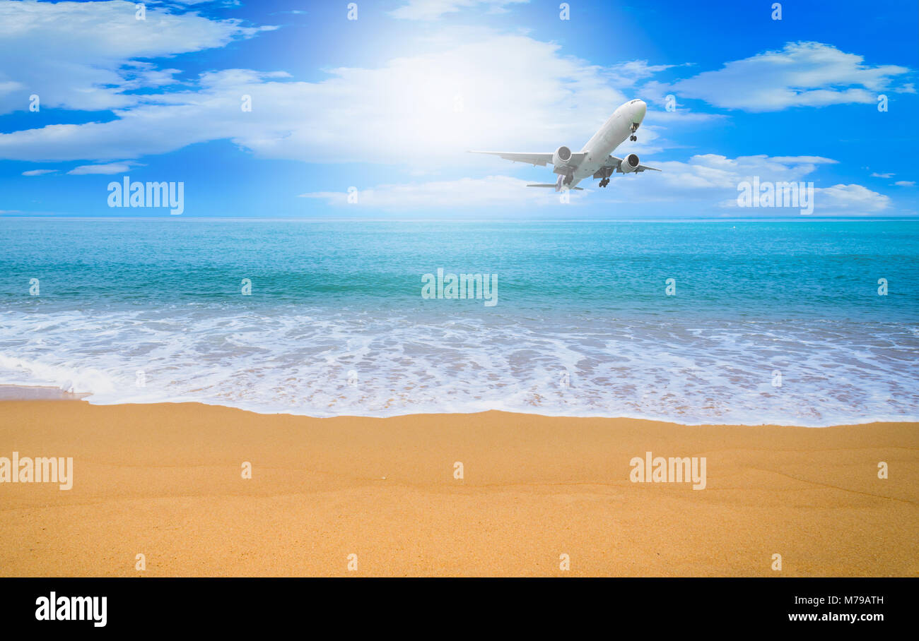 Plane flying on blue sky with cloud background over beach and tropical ...