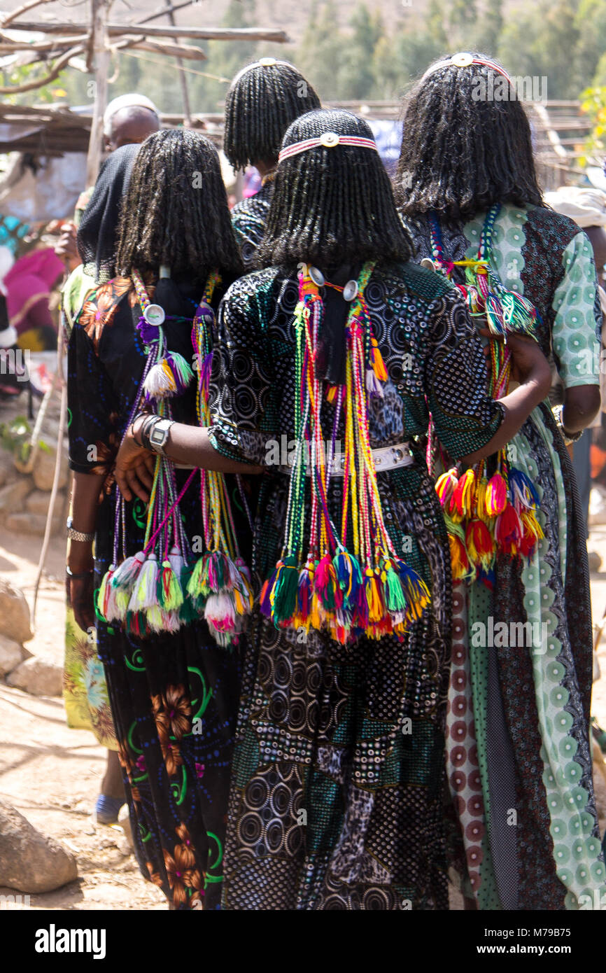 On a market day, Oromo girls with pompoms hanging in their back meaning ...