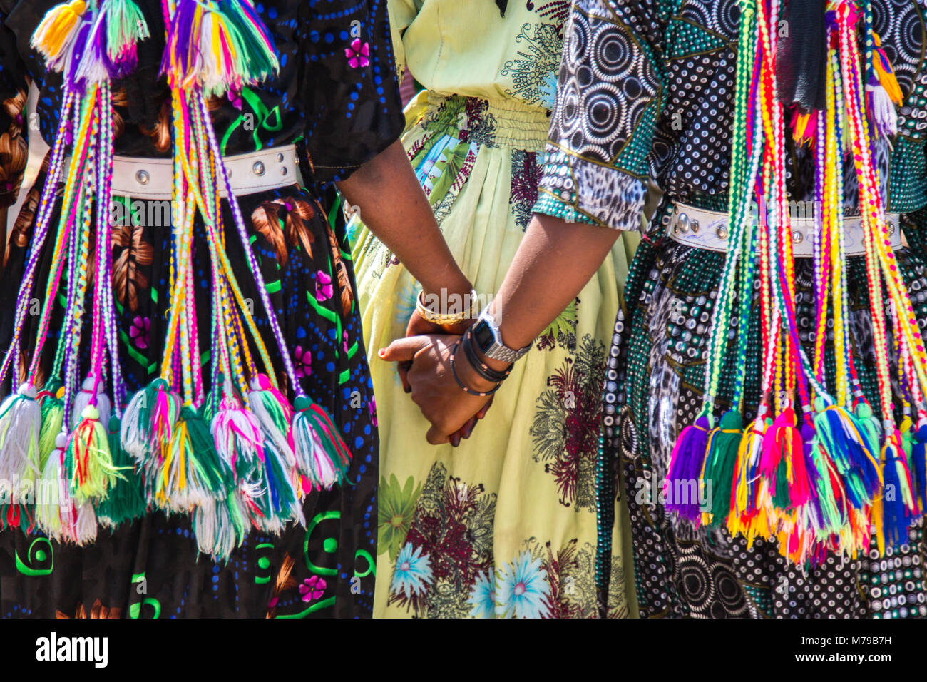 On a market day, Oromo girls with pompoms hanging in their back meaning ...