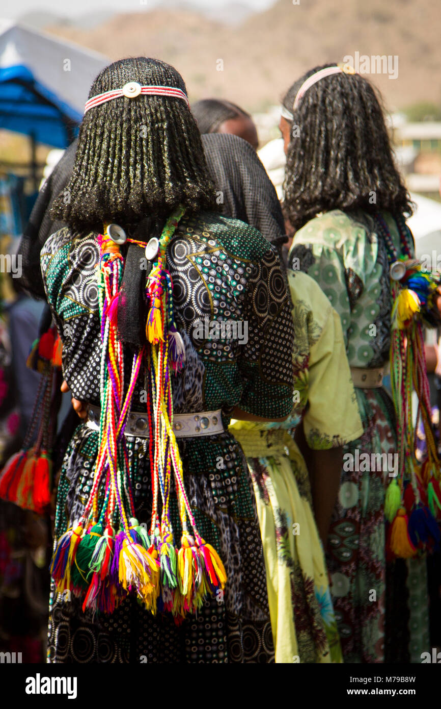 On a market day, Oromo girls with pompoms hanging in their back meaning ...