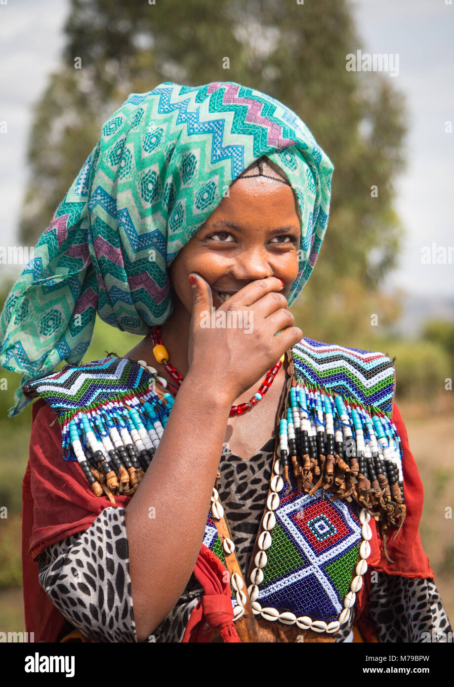 Raya tribe woman with a colorful beaded baby carrier in her back ...