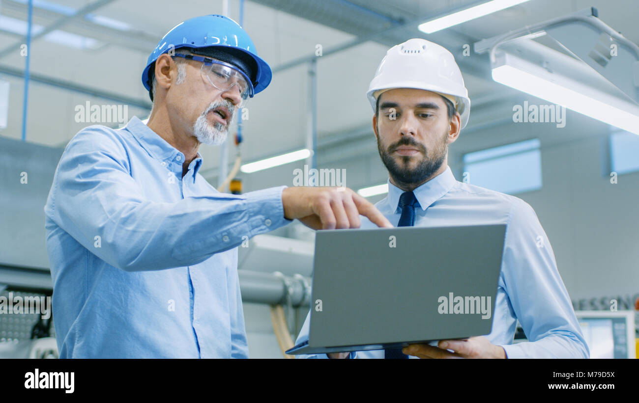 Head of the Department Holds Laptop and Discusses Product Details with ...