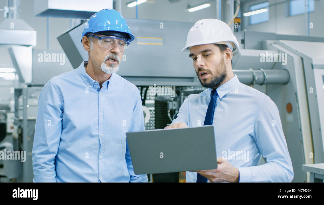 Head of the Department Holds Laptop and Discusses Product Details with ...
