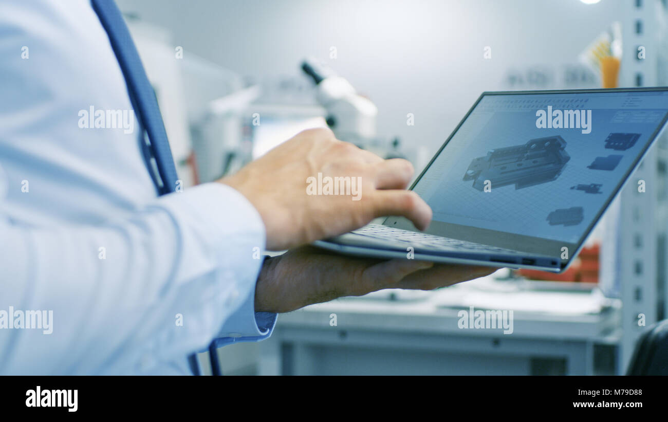 Close-up of the Engineer Holding Laptop with CAD Component Model on ...