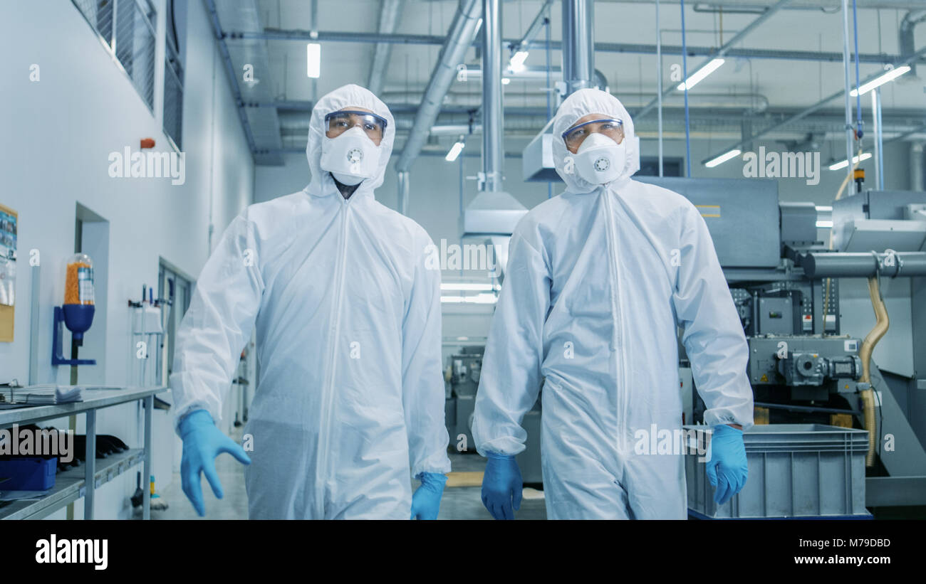 Two Engineers/ Scientists in Hazmat Sterile Suits Walking Through ...