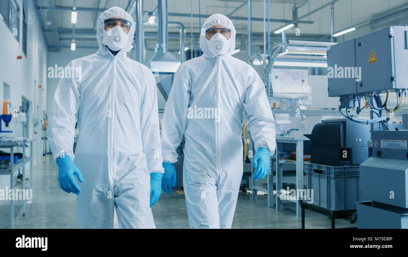 Two Engineers/ Scientists in Hazmat Sterile Suits Walking Through ...