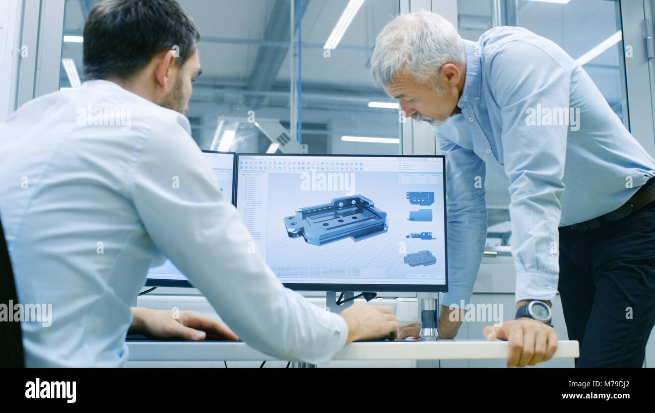 Industrial Designer Has Conversation with Senior Engineer While Working ...