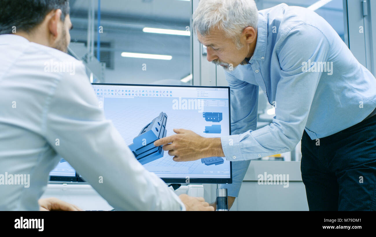 Industrial Designer Has Conversation with Senior Engineer While Working ...