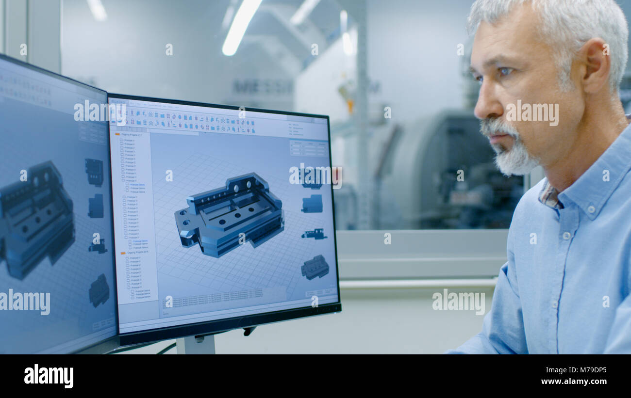 Engineer Working on a Personal Computer with Two Displays, He's ...