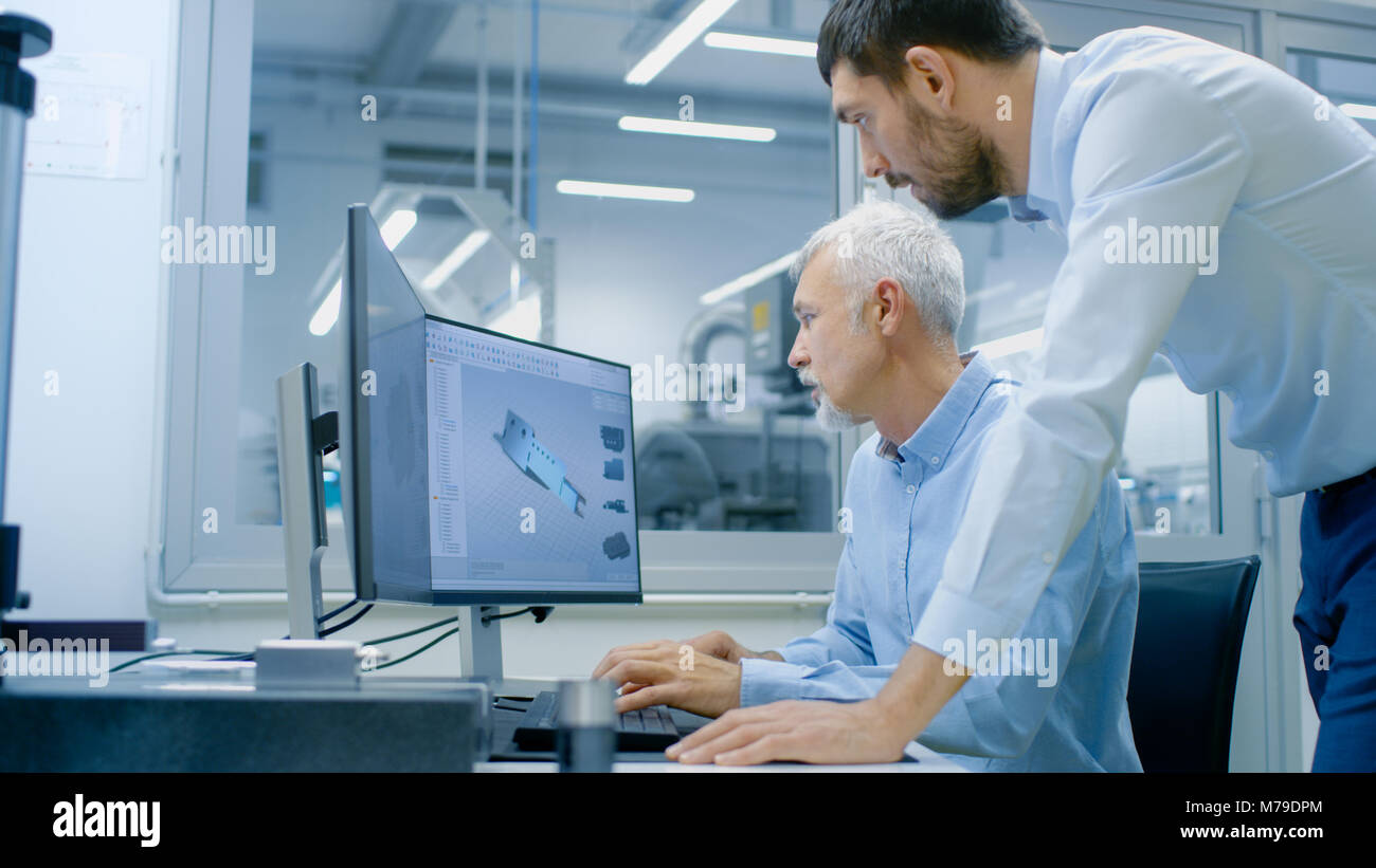 Industrial Designer Has Discussion with Senior Engineer While Working ...