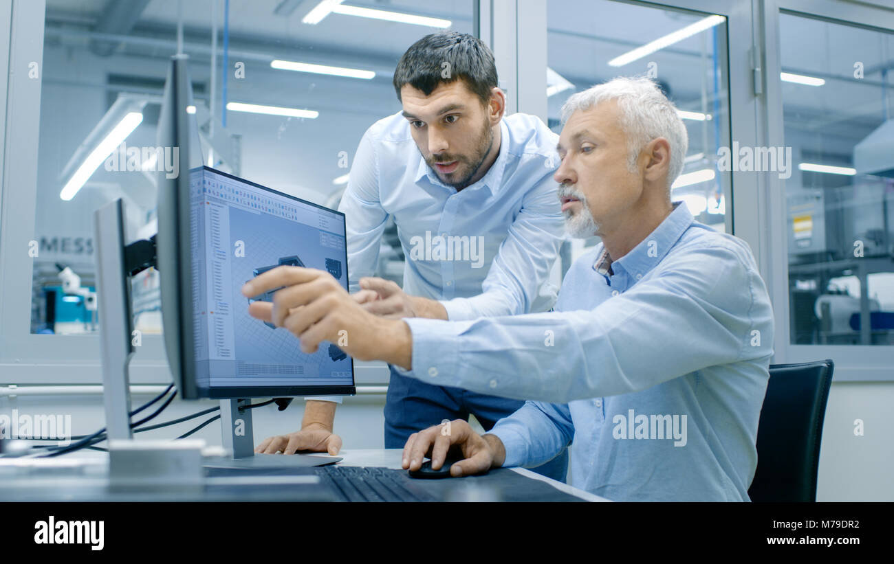 Industrial Designer Has Conversation with Senior Engineer While Working ...